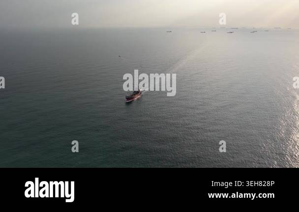 Aerial view of a solitary fishing boat sailing across the tranquil ...