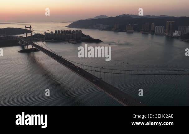 Majestic aerial view of traffic flowing across hong kongs tsing ma ...