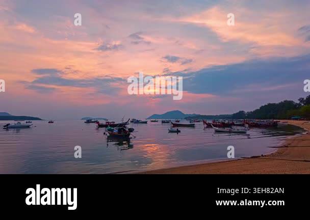Boats floating on calm water during sunset with colorful sky and ...