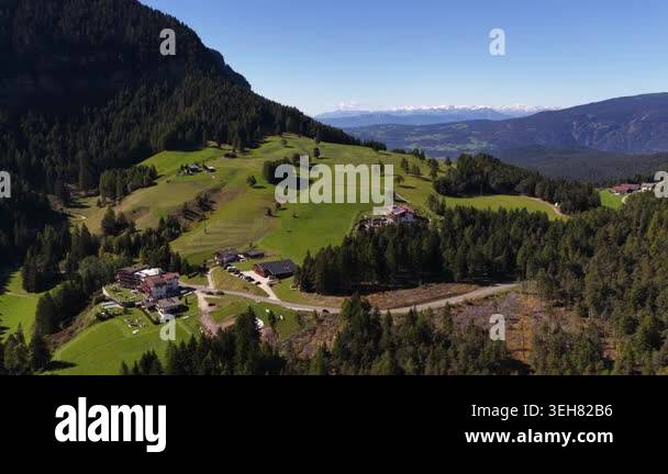 Scenic aerial shot slowly revealing a picturesque mountain village ...