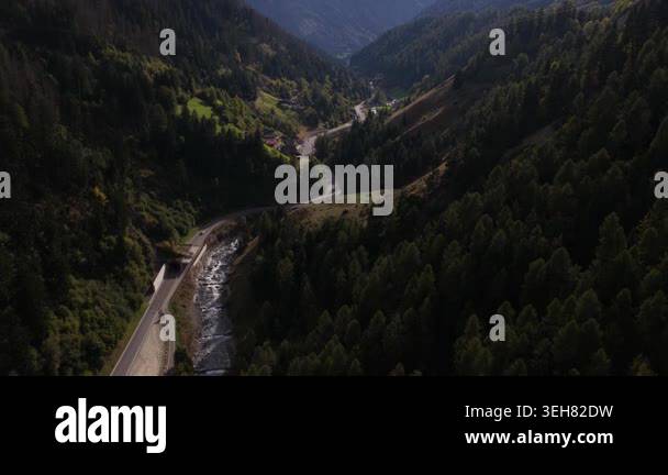 Aerial perspective revealing a stunning alpine valley with a river and ...
