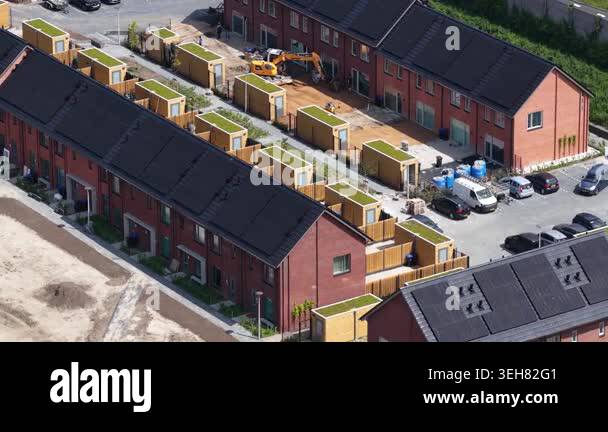 High angle view of a construction site with an excavator leveling the ...