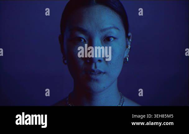 Asian woman closeup under blue light, studio portrait sequence showing ...