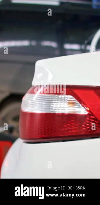 Car service - red backlights of white auto close up Stock Video Footage ...