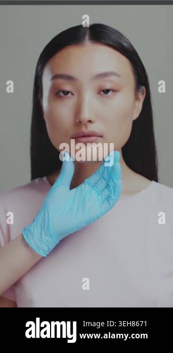 woman receiving lip injection from gloved hands, blue gloves supporting ...