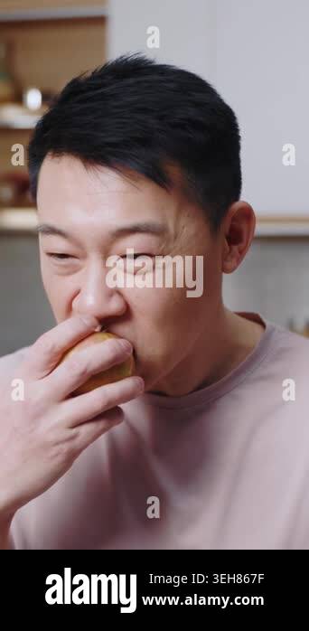 asian man tasting bite in kitchen closeup portrait, playful reaction ...