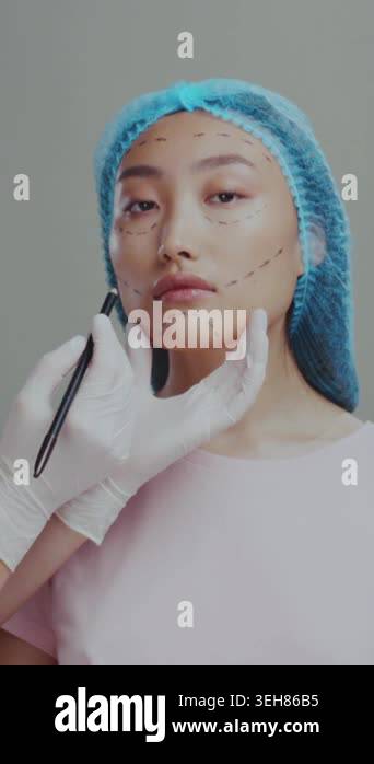 asian woman aesthetic mapping with pen dermatologist evaluates facial ...