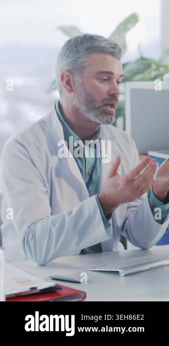 white male doctor explaining treatment plan with hand gestures in ...