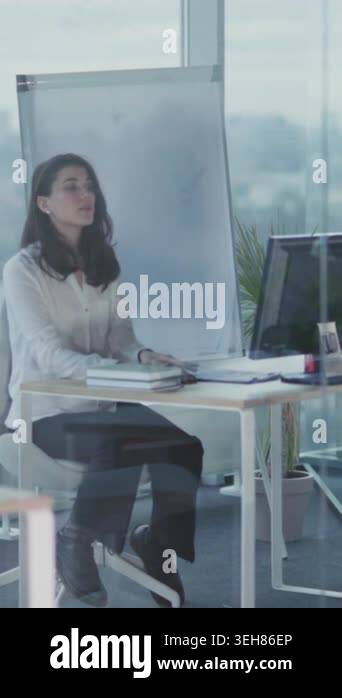office desk caucasian woman writing interrupted by bright green ...