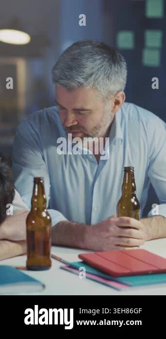nighttime office manager offering beer caucasian senior consoling ...
