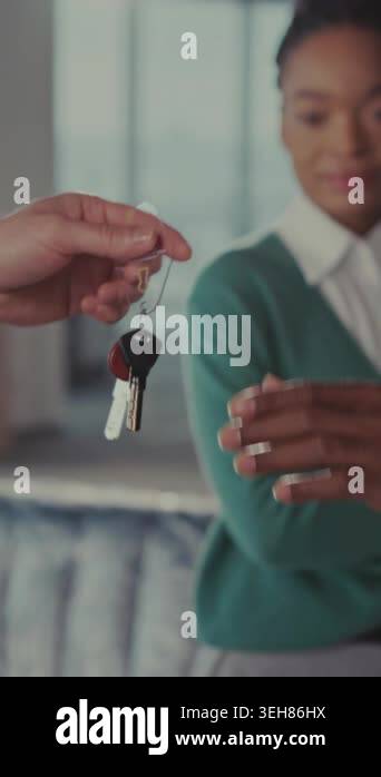 couple exchanging apartment keys smiling woman in green sweater ...