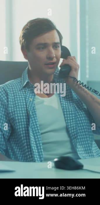 caucasian man in office on phone, answers urgent call, brows furrowed ...