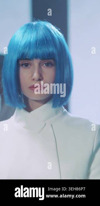 white woman blue wig examining hologram tablet in sterile white uniform ...