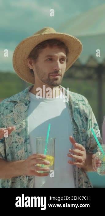 casual harbor conversation with caucasian man, straw hat and lemonade ...