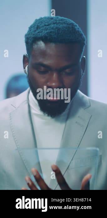 black man in suit examining holographic display sequence shows ...