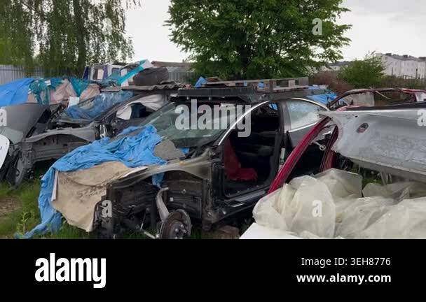 Electric car junkyard. Car beyond repair after accident. Car rusting in ...