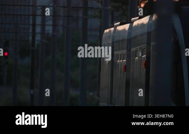 A train moves slowly towards the station during evening hours. Signals ...