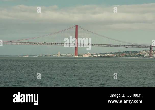 The camera shows the 25 de Abril Bridge in Lisbon. The bridge connects ...