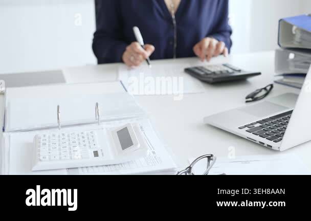 Close up of white calculator over financial documents opposite ...