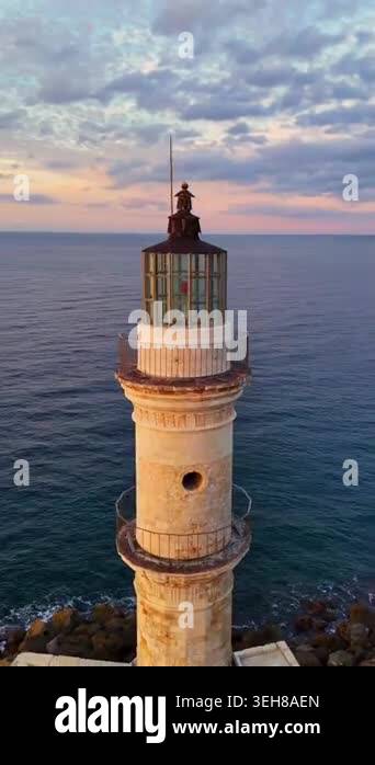 The old lighthouse in Chania from a drone's view during sunset. The ...