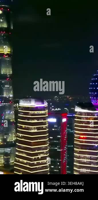 View Shanghai City lit up at night from above. The lighting showcases ...