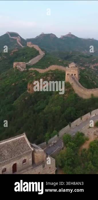 This captures a drone view of the Great Wall of China surrounded by ...