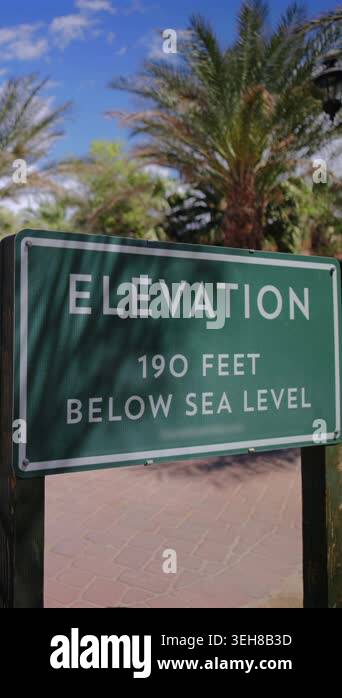 Vertical Screen: Green road sign displaying elevation 190 feet below ...