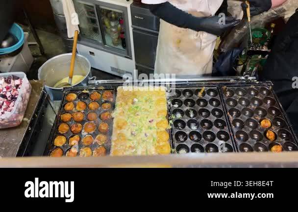 OSAKA, JAPAN - APRIL 17, 2026: Street food vendor cooking traditional ...