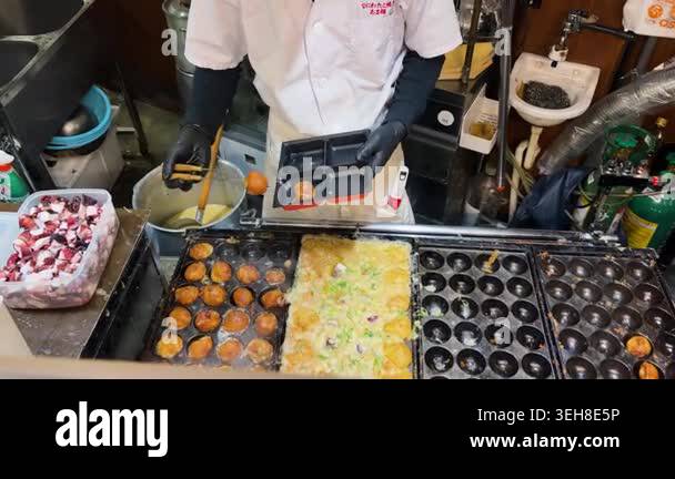 OSAKA, JAPAN - APRIL 17, 2026: Street food vendor cooking traditional ...
