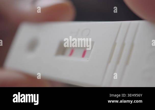 A close-up shows a pregnancy test with two lines on the display Stock ...
