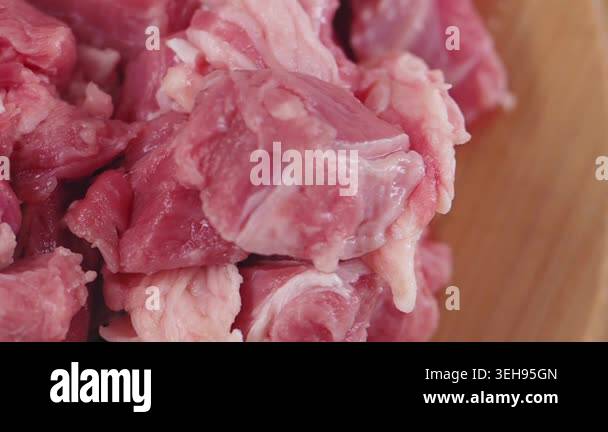 This shows raw meat being cut into pieces for cooking later Stock Video ...