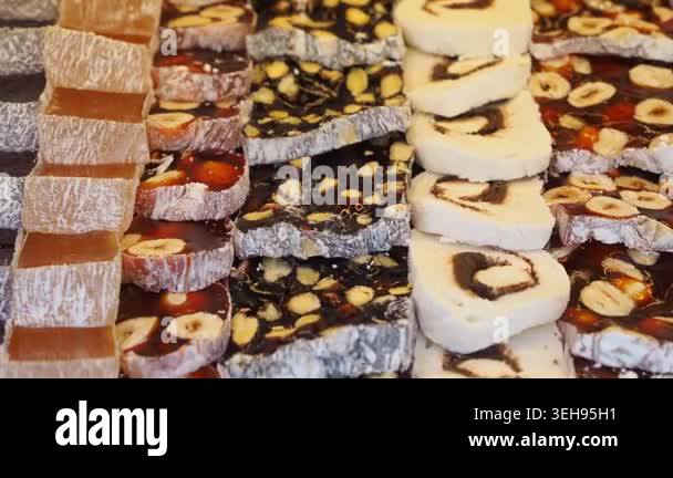 Turkish Sweet treats made with nuts and fruits in a market display ...