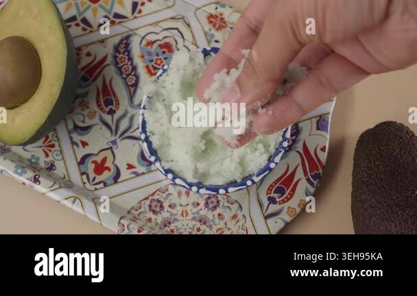 Mixing avocado and sugar to create a scrub for skin care Stock Video ...