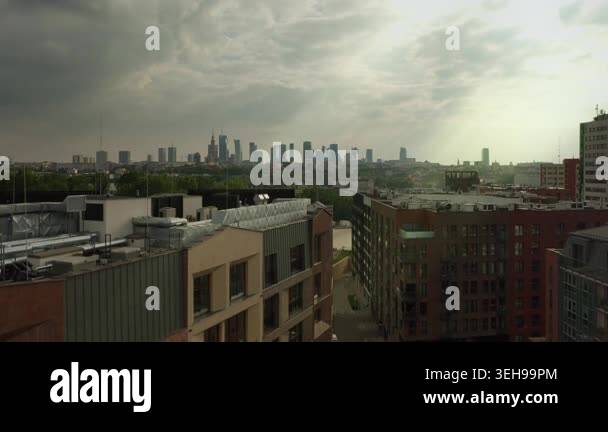 Aerial view rising above residential apartment rooftops reveals the ...
