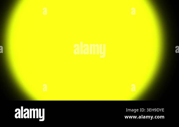 Seamless loop animation of yellow flashlight glow on a black background ...