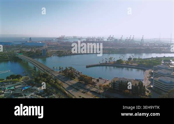Drone approach to Port of Long Beach with harbor cranes and bridge ...