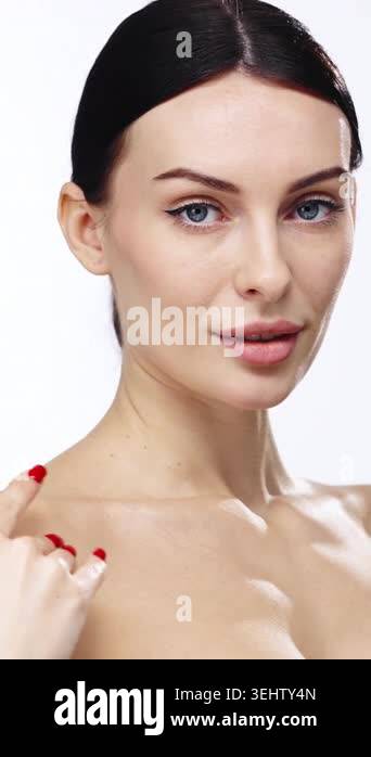 Young woman with beautiful skin posing against a white background ...