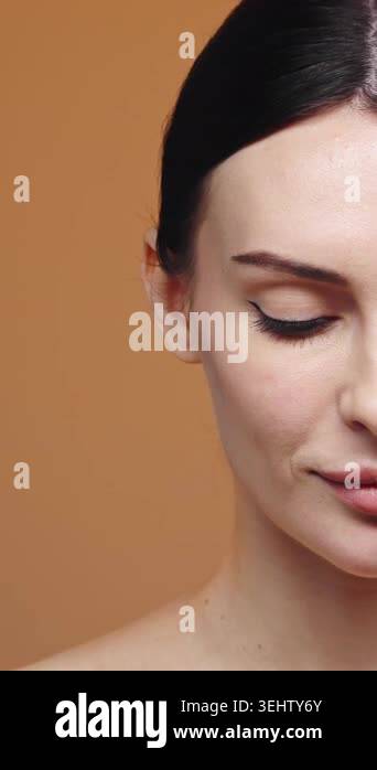 Close-up of a young woman with eyes closed and serene expression ...