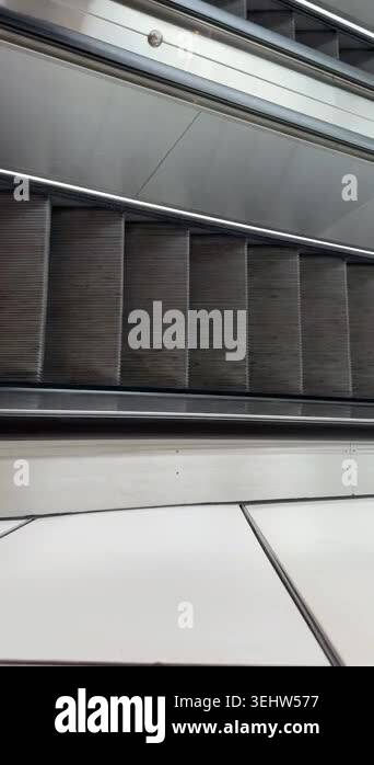 View from above of the moving parts of rows of escalators. Steps and ...