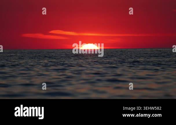 Vivid red sun touching ocean horizon, peaceful Italy sunset scene in 4K ...