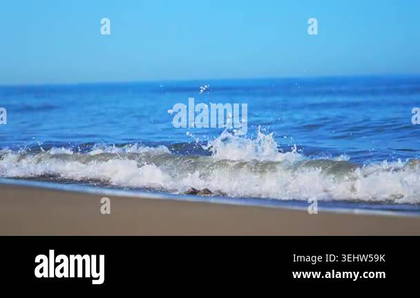 Beautiful sea surf and blue sky creating a peaceful summer beach scene ...