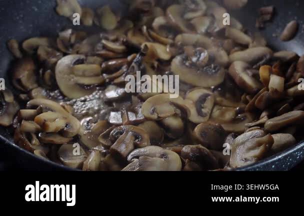 Frying champignons in pan and mixing with spatula Stock Video Footage ...
