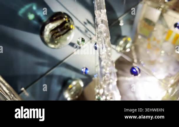 Abstract glass installation with suspended spheres and mirrored ...