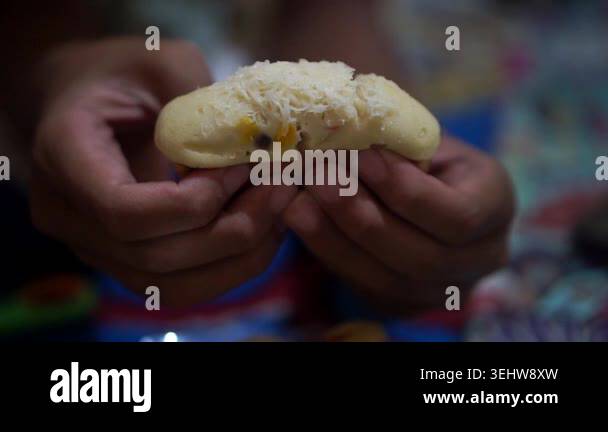 Warm pukis cake with soft cheese topping being split by hand Stock ...