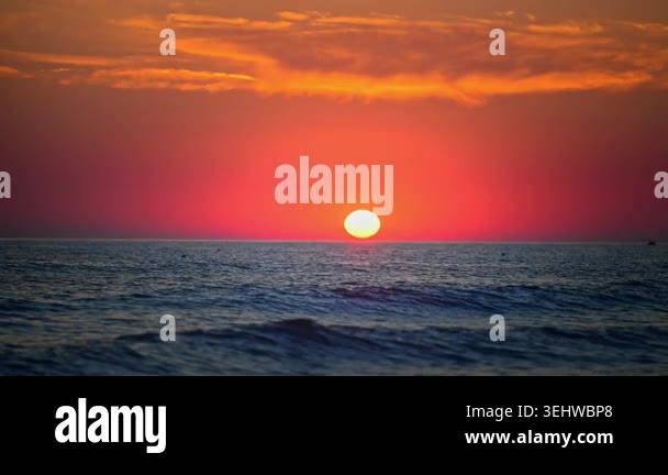Golden sun setting over peaceful ocean horizon with vibrant evening sky ...