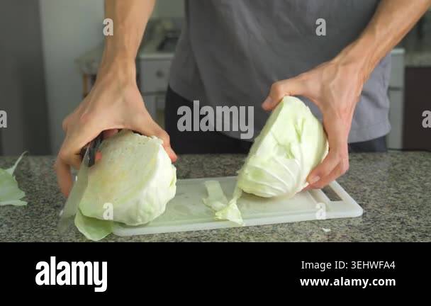 Close up man cutting cabbage with knife with clear sound. Hands slicing ...