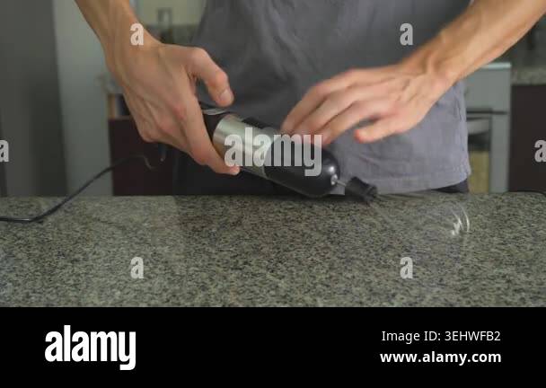 Close up man turning on hand mixer with clear sound. Hands operating ...
