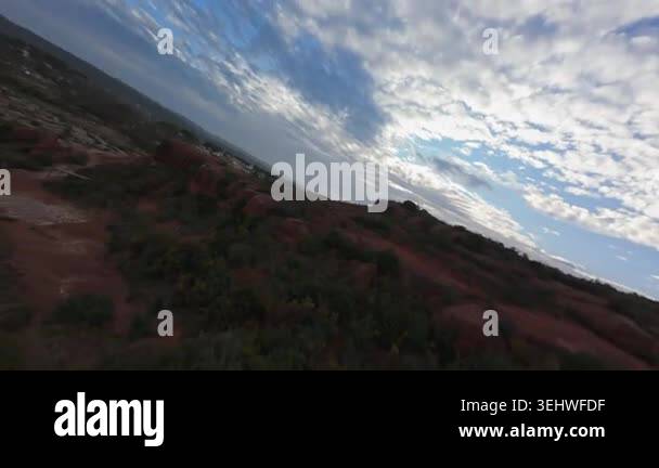 FPV drone cinematic banking turn over red rock ridges and valley at L ...