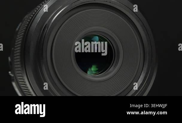 Black macro camera lens, zoom-in video on black backdrop Stock Video ...