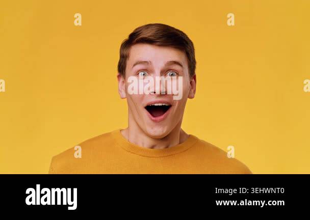A man with light skin shows a surprised expression. He has short brown ...